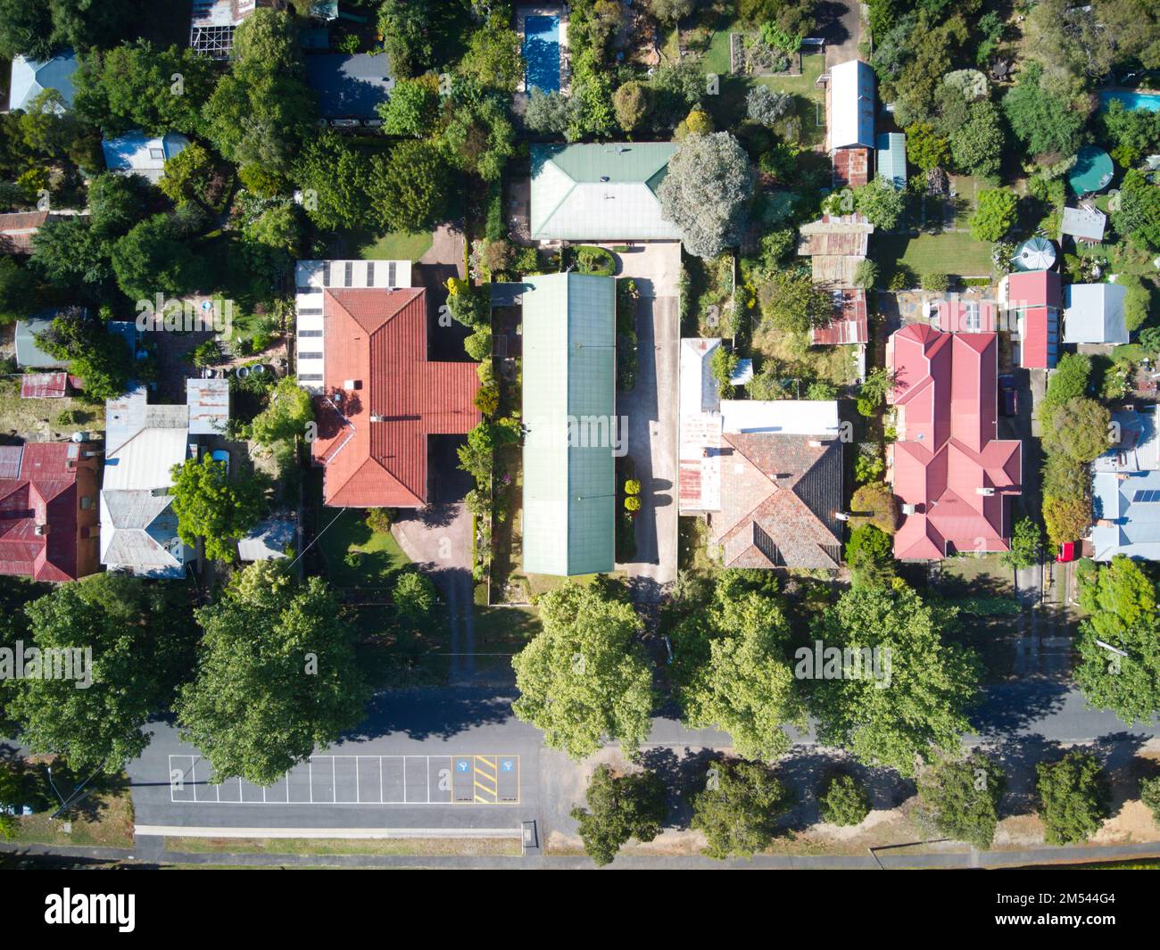 Residential street showing suburban houses from above, green trees ...