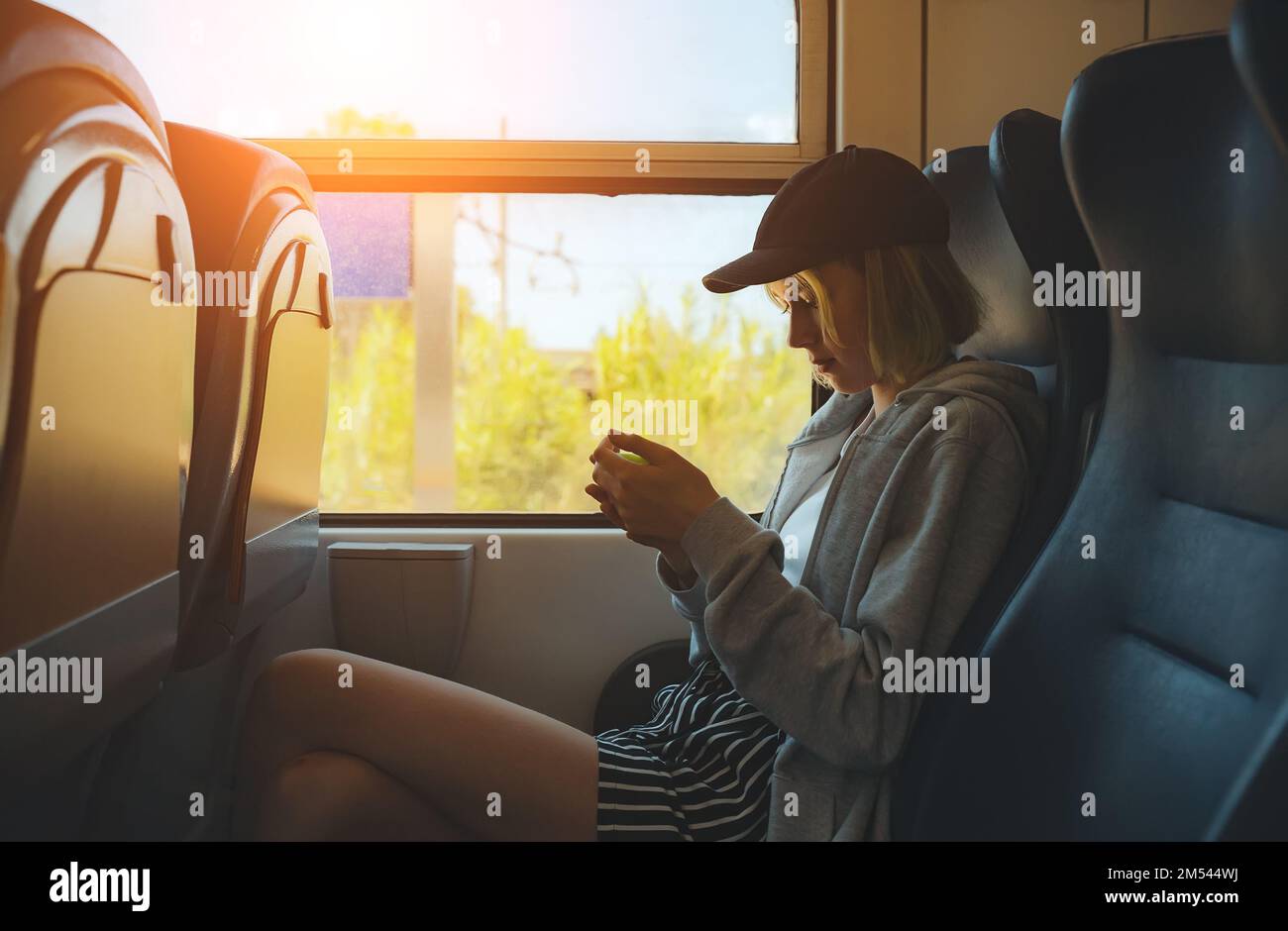 Teenage girl with smartphone travelling inside the train Stock Photo ...