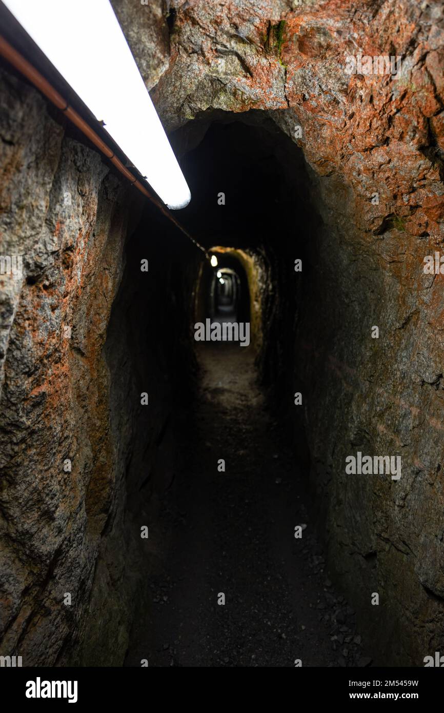 A vertical of the pathway through a cave tunnel Stock Photo - Alamy