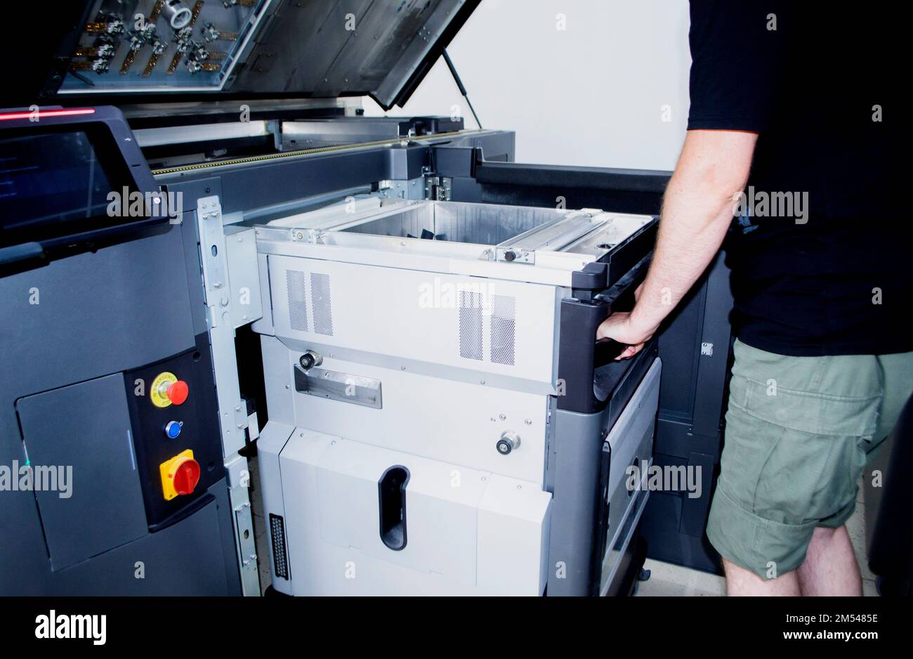 The worker moves the working camera of the 3D printer into the 3D ...