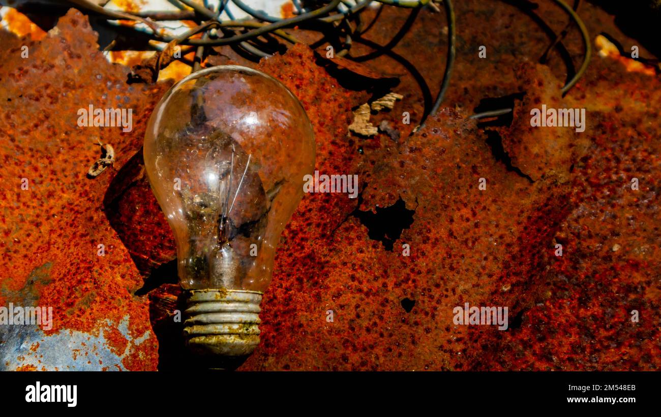 Light bulb on rusty zinc as background Stock Photo - Alamy