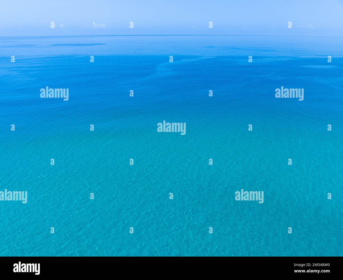 Aerial view of blue sea surface water texture background and sun ...