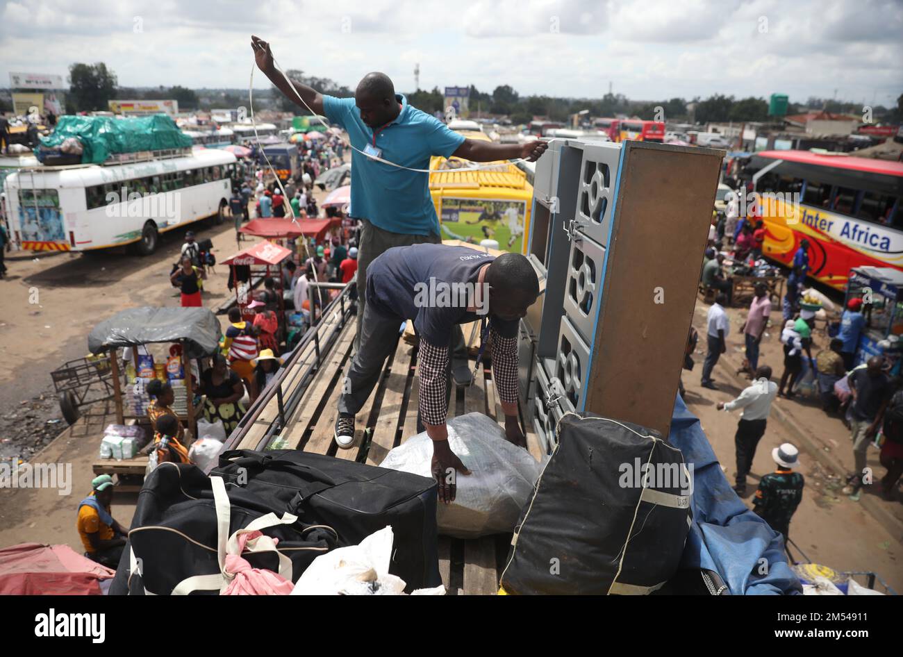 Harare, Zimbabwe. 19th Dec, 2022. People load luggage on top of a rural bus to go for Christmas ...