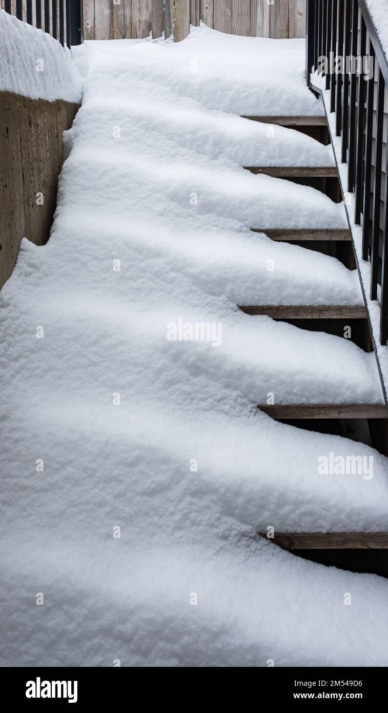 Snow covered on wooden stairs house in winter. Snow covered steps ...