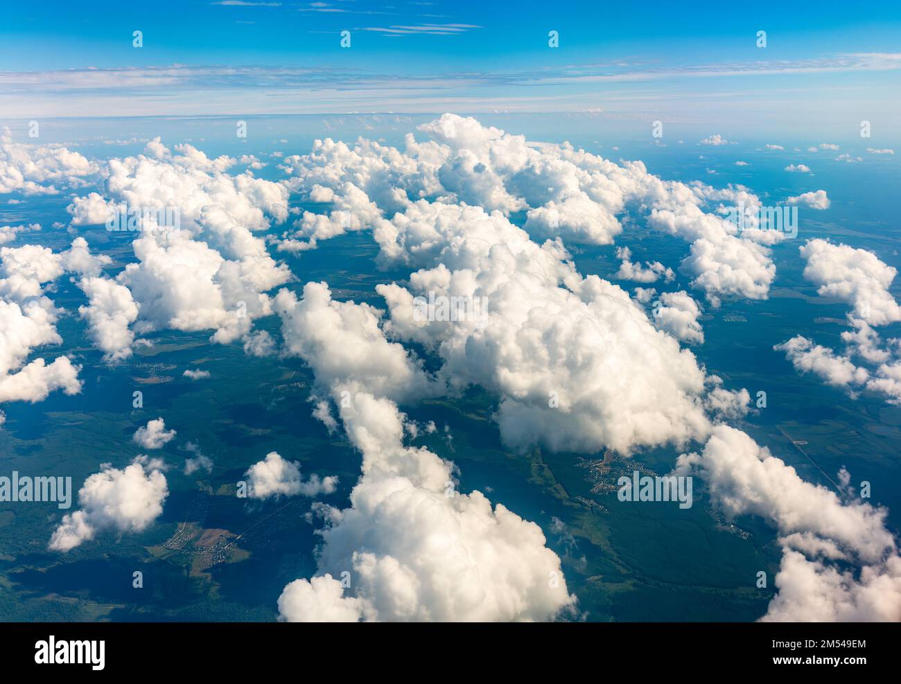 Aerial view from airplane window above green ground. View from the ...