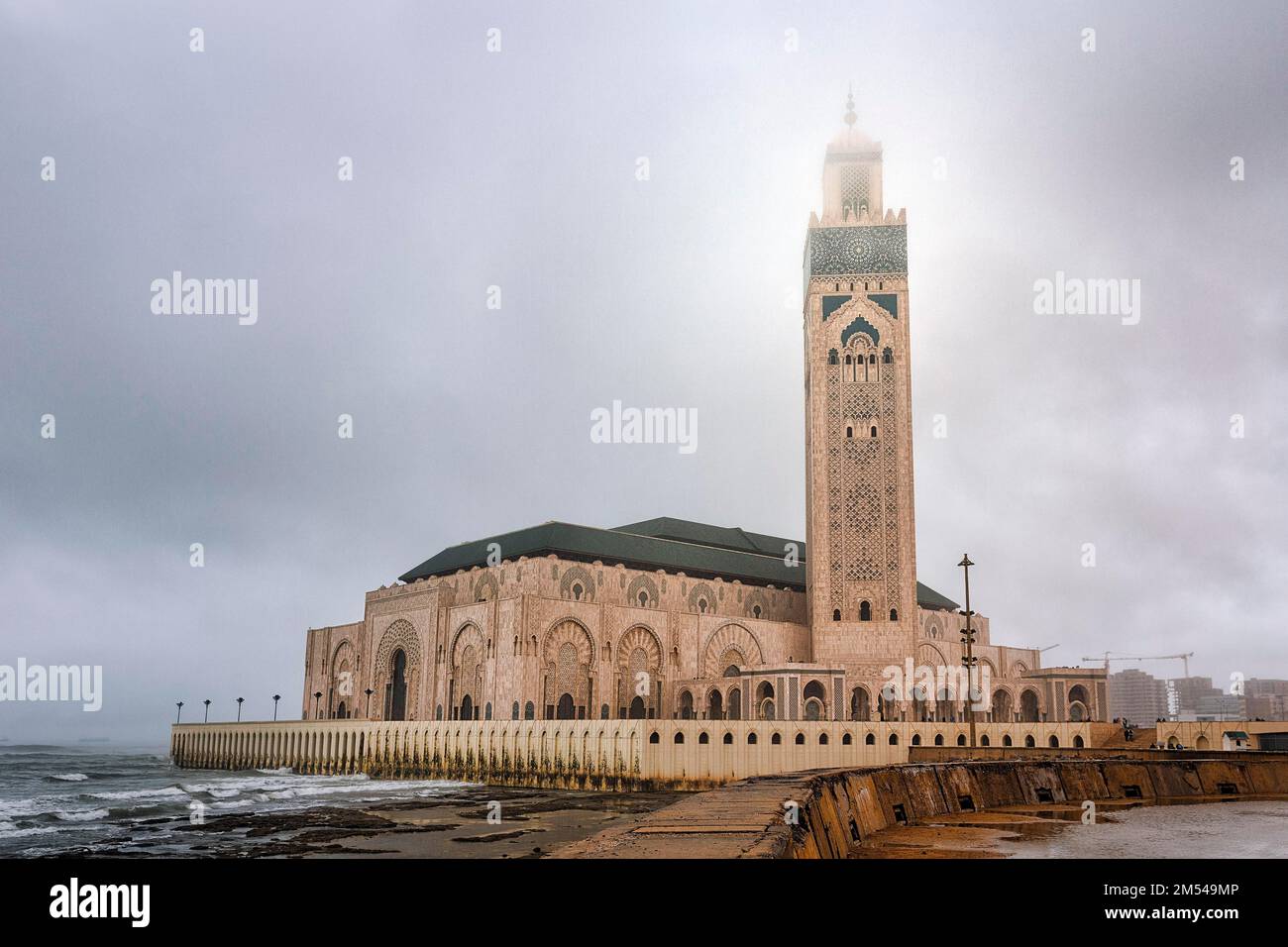 Hassan II Mosque on rocky coast, Moorish architecture, cloudy, minaret ...