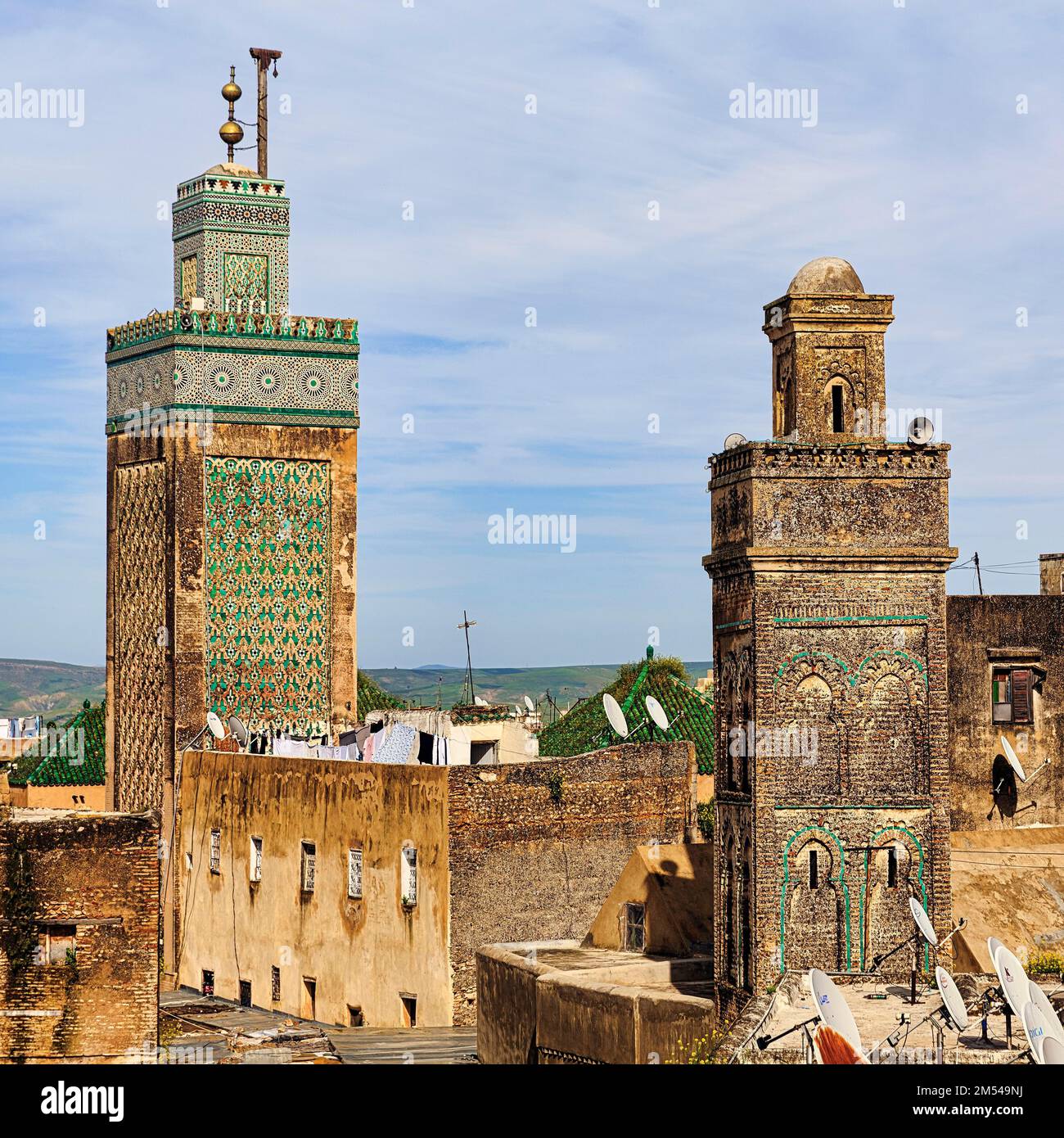 View from above rooftops of two minarets and the 14th century Medersa ...
