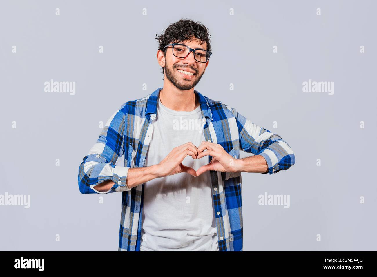 Teenage guy making heart shape with hands isolated. Happy man making ...
