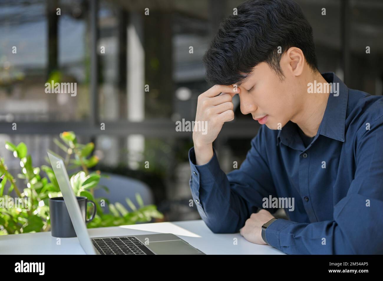 Young businessman stressed about his project and have a headache during ...