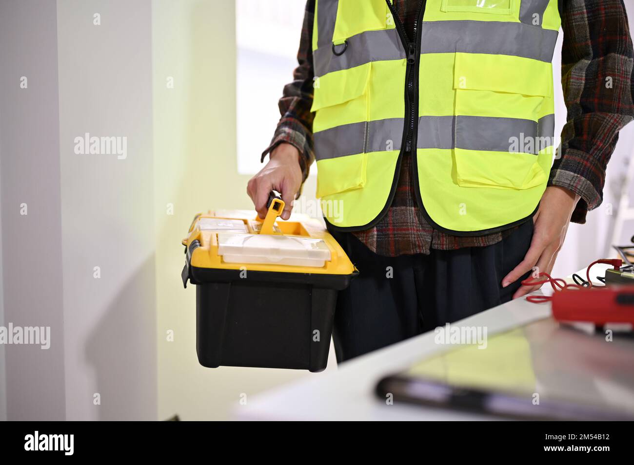 Professional Asian male construction worker in uniform holding a ...