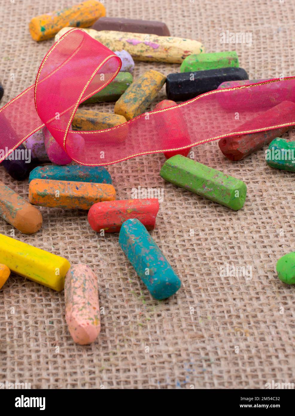 Used crayons of various color wirh a ribbon Stock Photo - Alamy