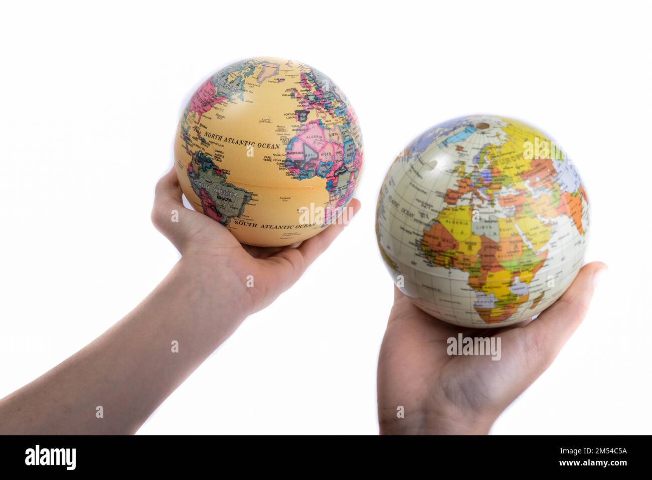 Two hands holding holding two globes in hand on white background Stock ...