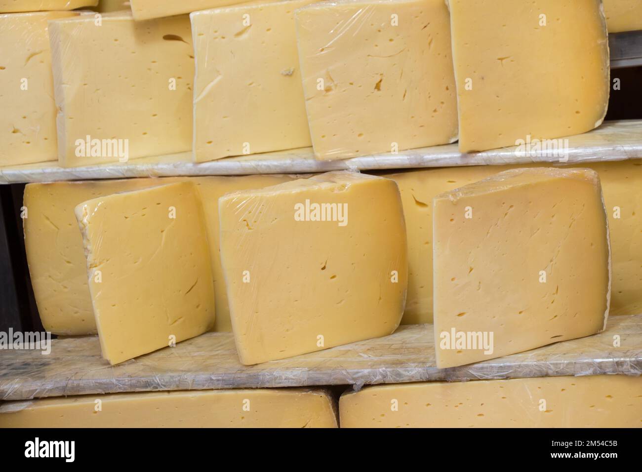 Cuts of kashkaval or kasseri cheese for sale on the shelf Stock Photo ...