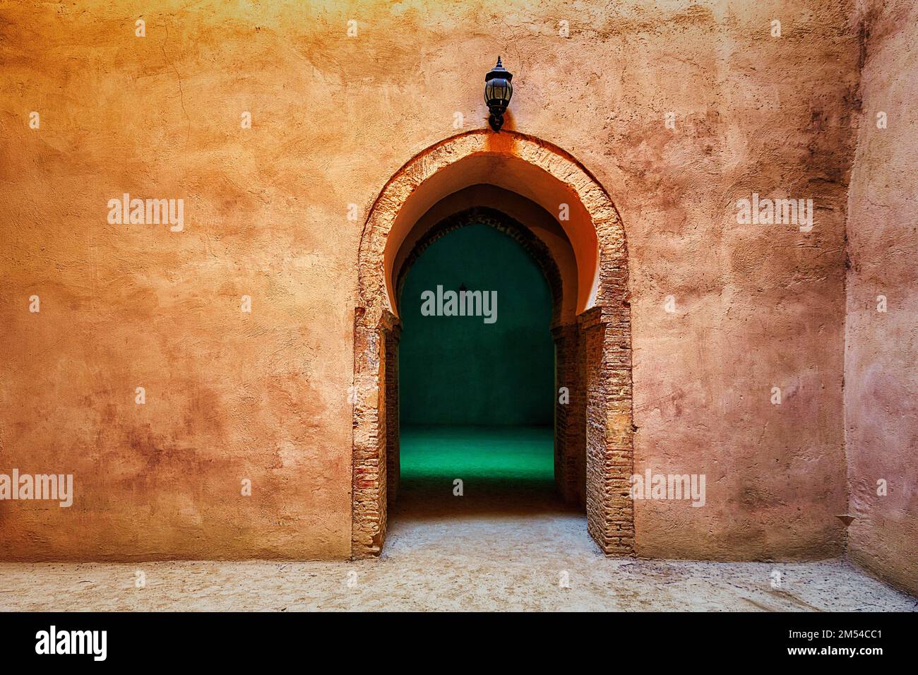 Archway in plain clay wall, access to the green-lit cistern, store in ...