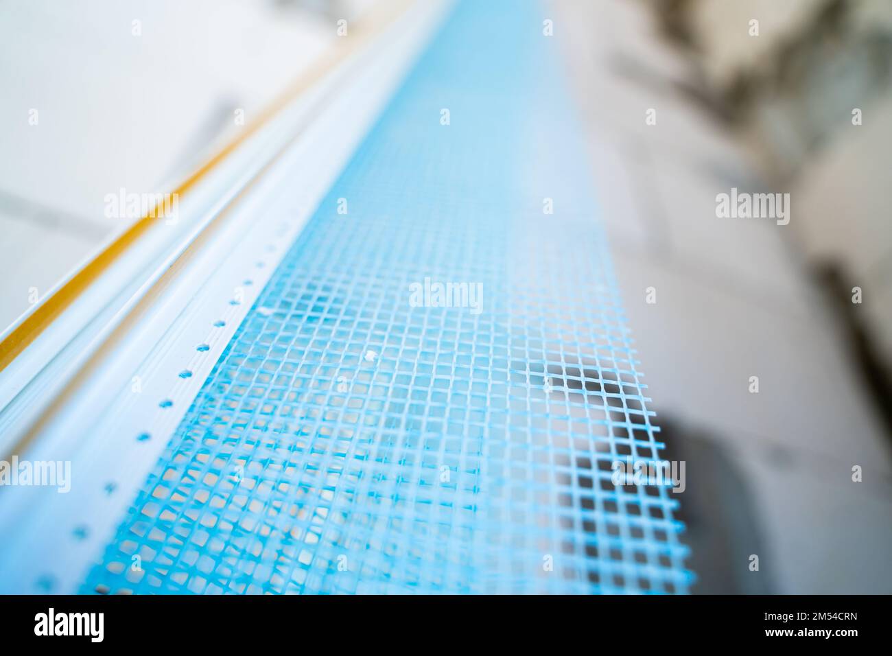 Window profile adjoining with a blue mesh close-up against the ...