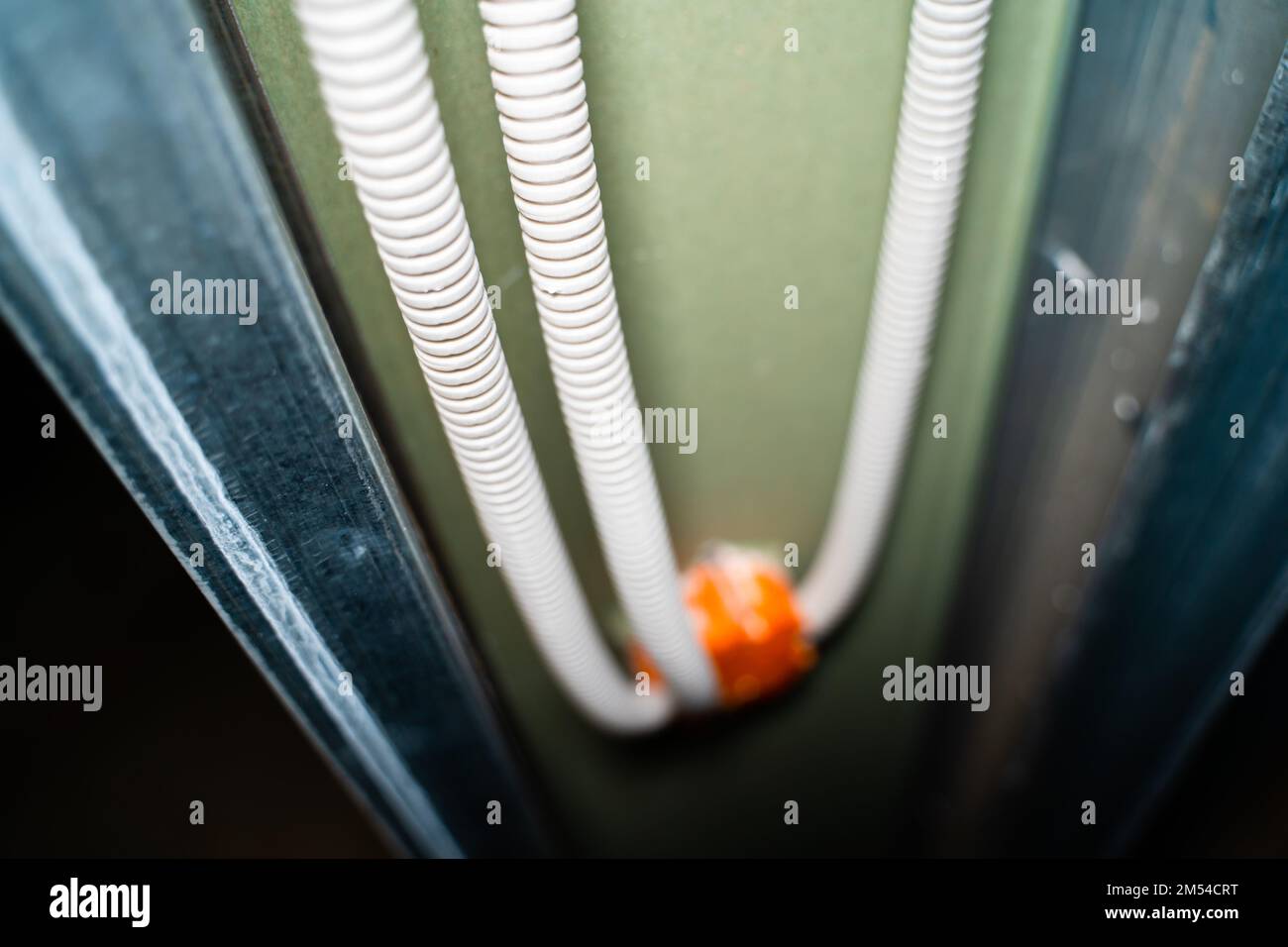 The wires in the protective corrugated pipe are led inside the socket ...
