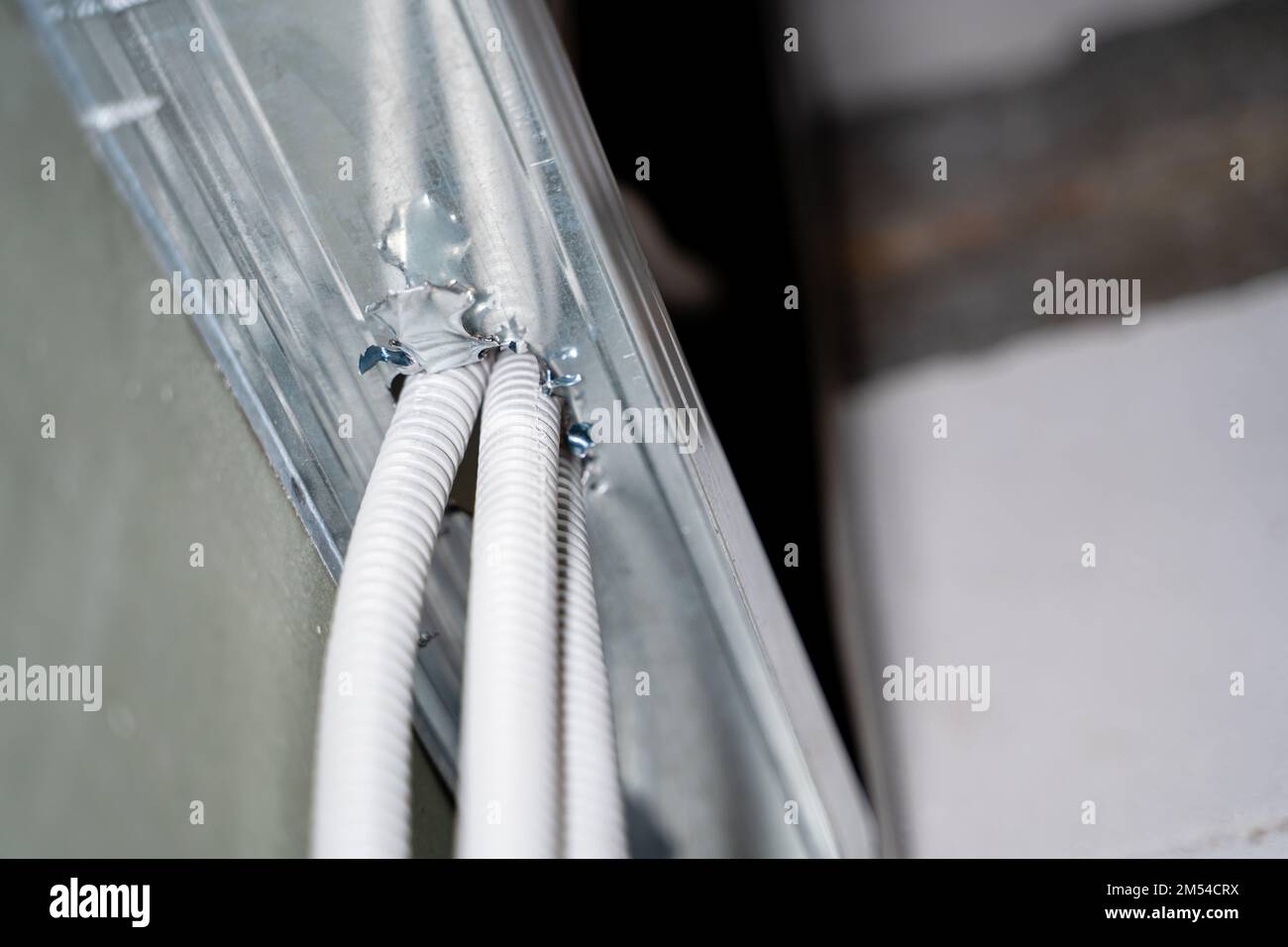 The wires in the protective corrugated pipe are led through the hole ...