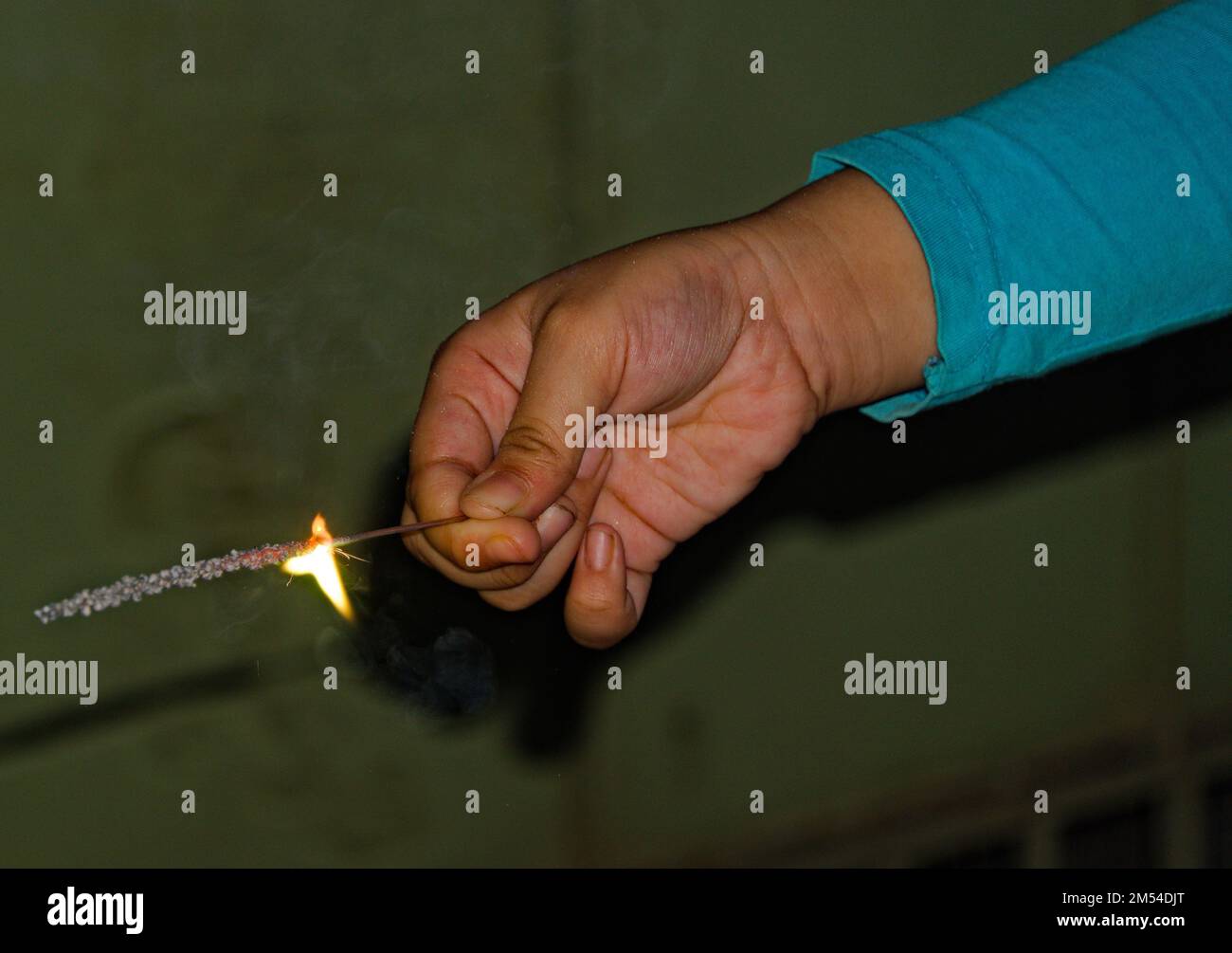 burning electric sparklers for diwali celebration during night time in ...