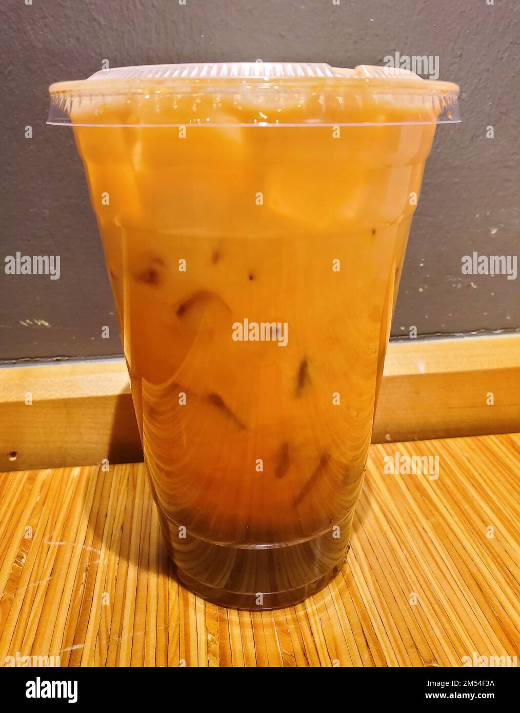 A medium size cup of a cold drinks of Thai Tea with ice cubes Stock ...