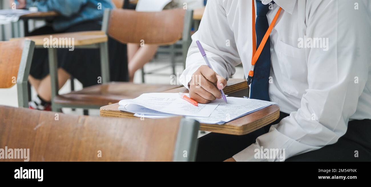 The college students writing on final examination papers in the ...