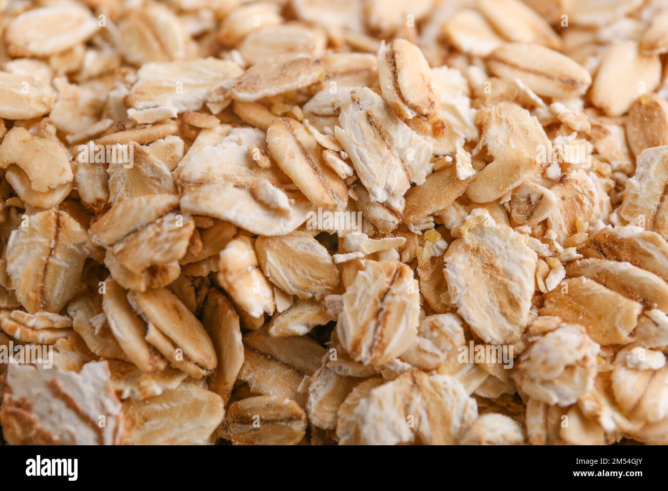 Raw oat flakes as background, closeup Stock Photo - Alamy