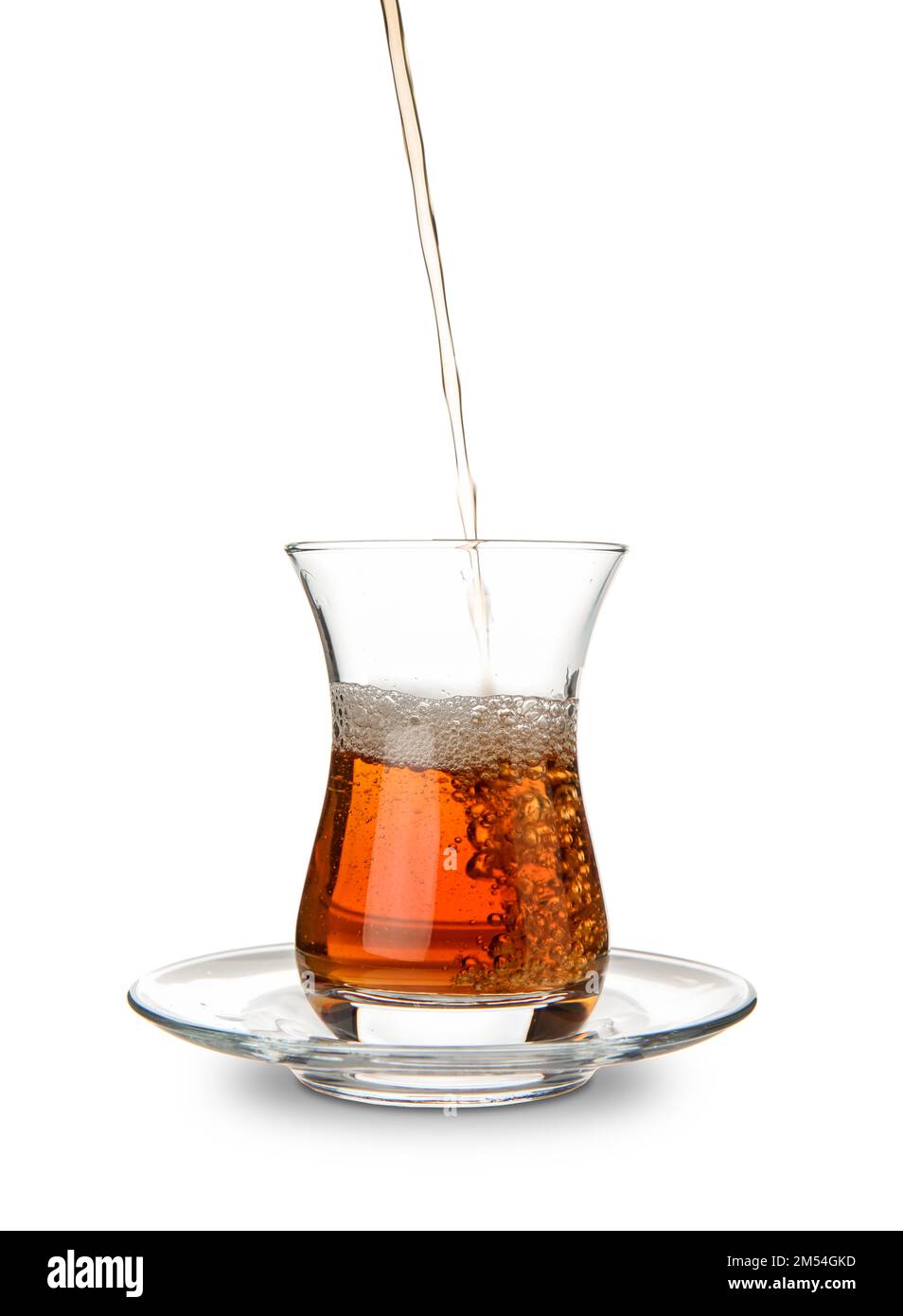 Pouring of Turkish tea into glass on white background Stock Photo - Alamy