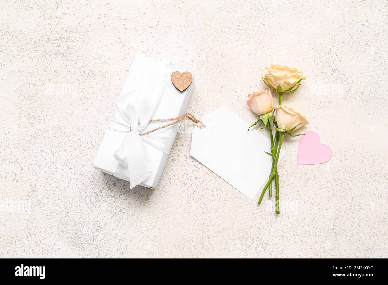 Composition with gift box and beautiful rose flowers on light ...