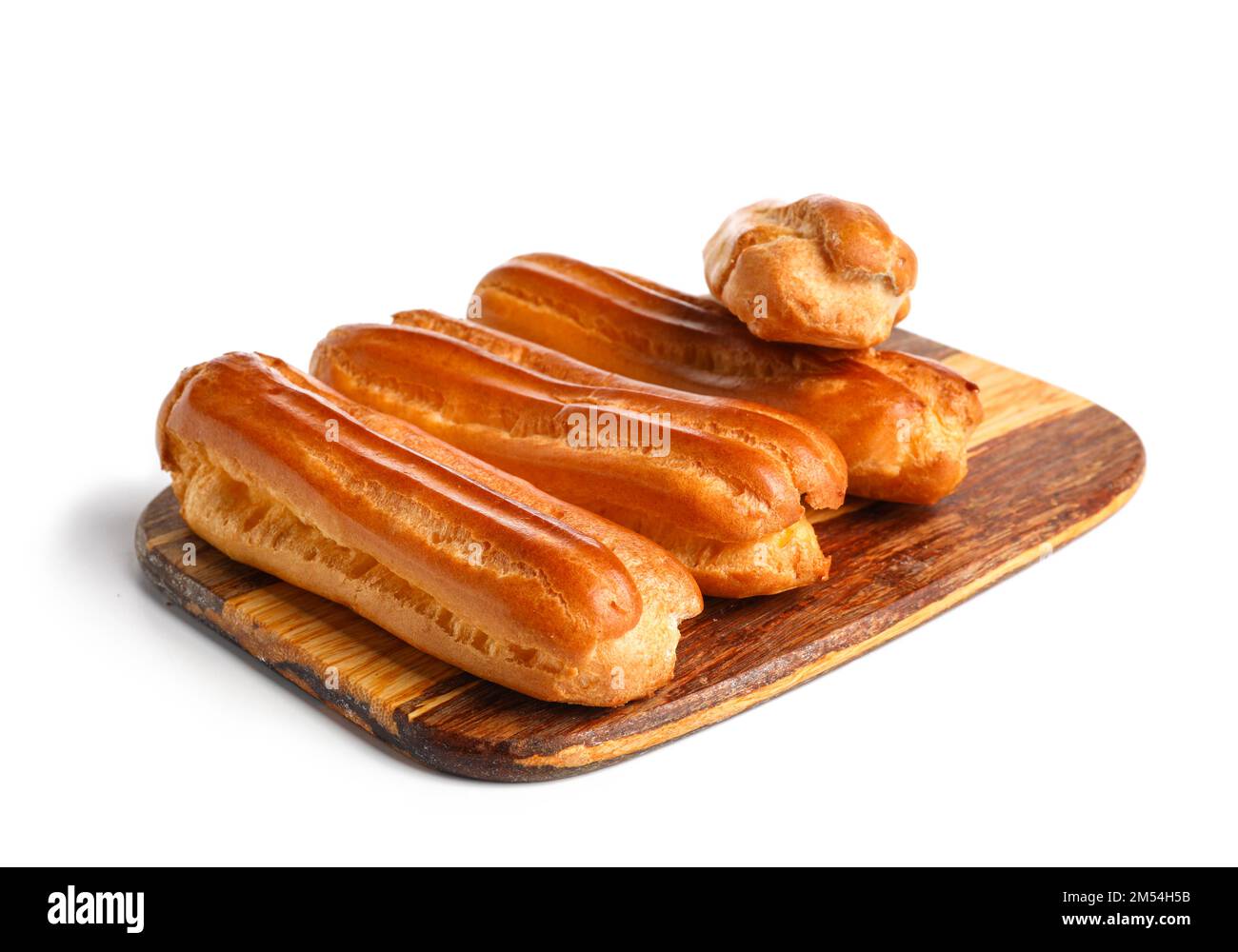 Wooden board with sweet eclairs isolated on white background Stock ...