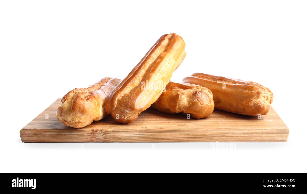 Wooden board with tasty eclairs isolated on white background Stock ...