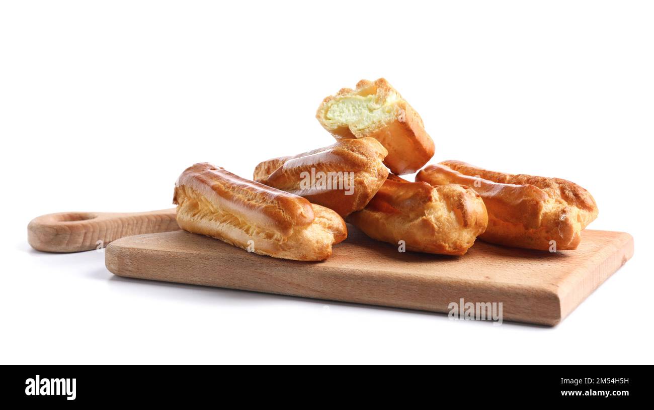 Wooden board with sweet eclairs on white background Stock Photo - Alamy