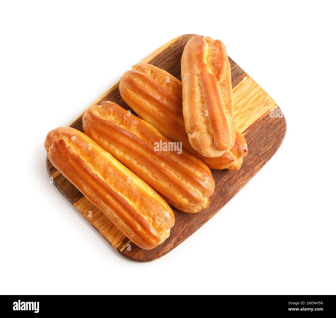 Wooden board with sweet eclairs isolated on white background Stock ...