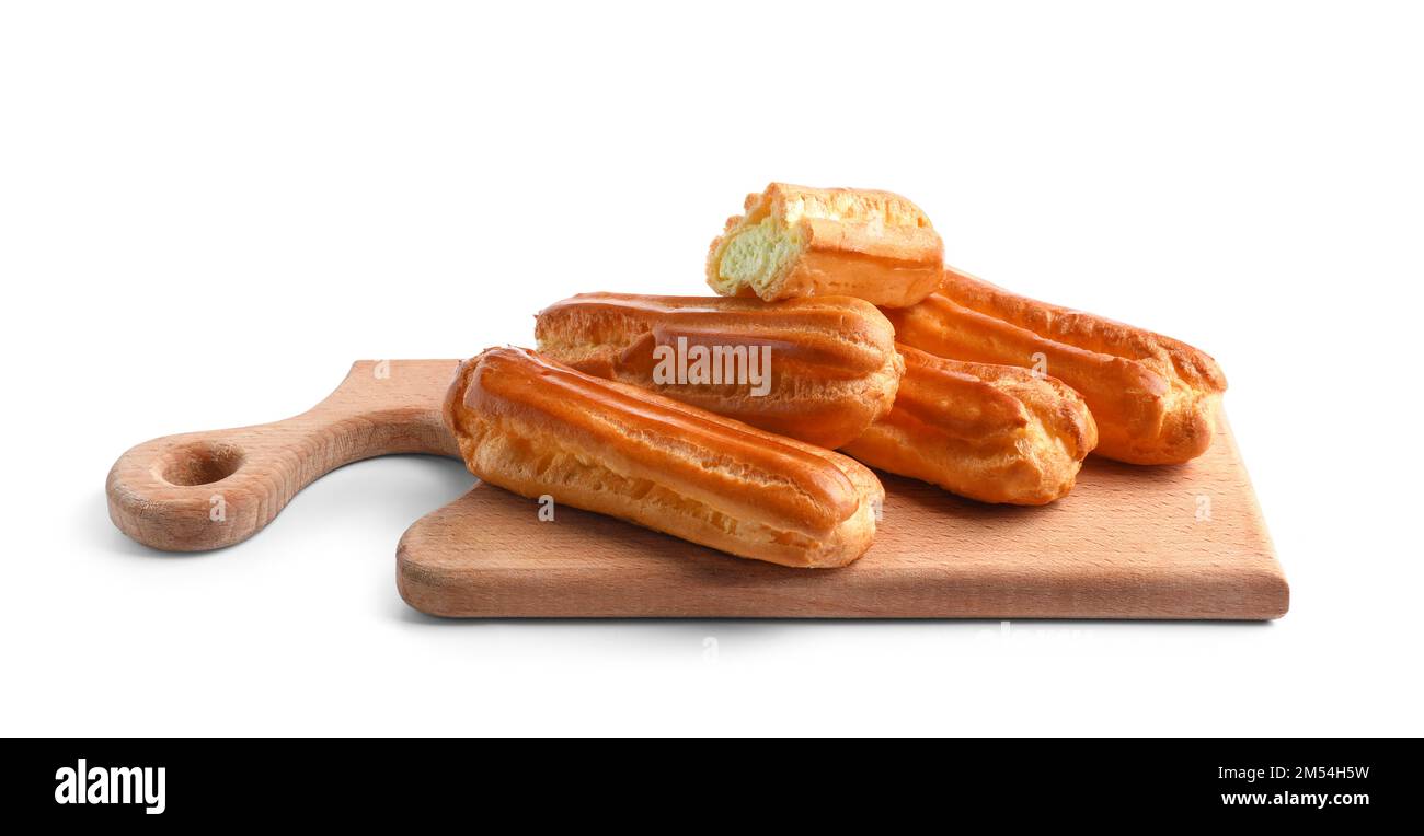 Wooden board with sweet eclairs on white background Stock Photo - Alamy
