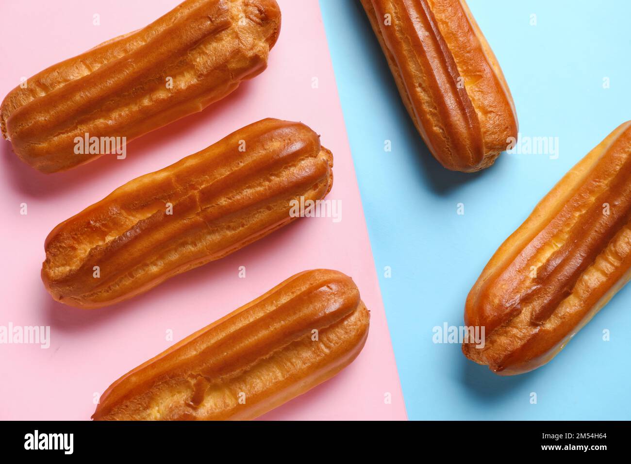 Delicious eclairs on color background Stock Photo - Alamy
