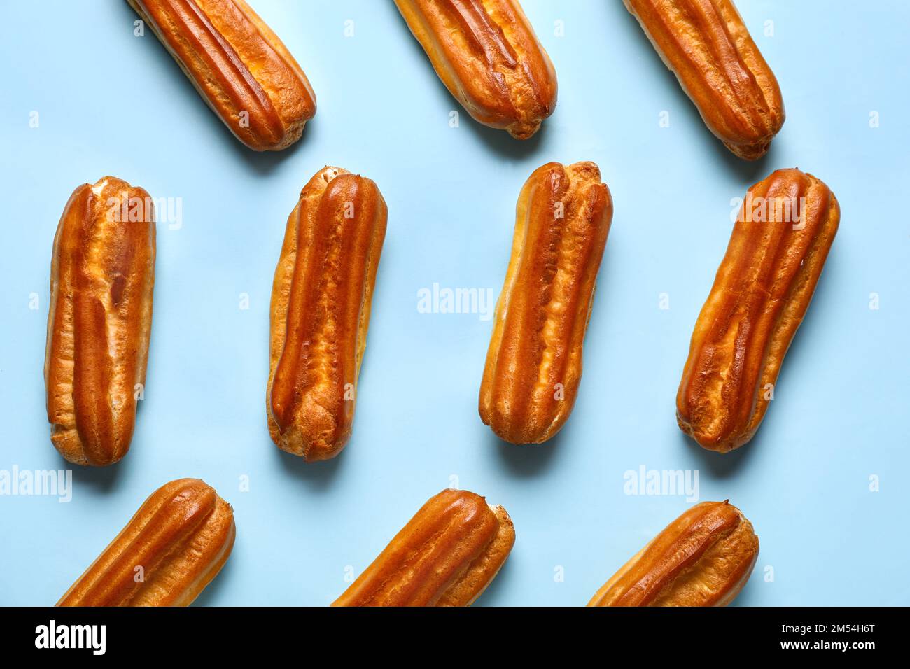 Many sweet eclairs on color background Stock Photo - Alamy