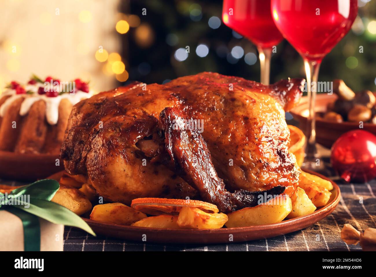 Plate with tasty chicken and potato on Christmas dining table in room ...
