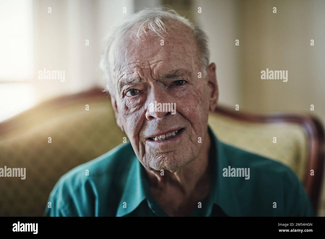 The golden years is just that, golden. a senior man sitting by himself ...