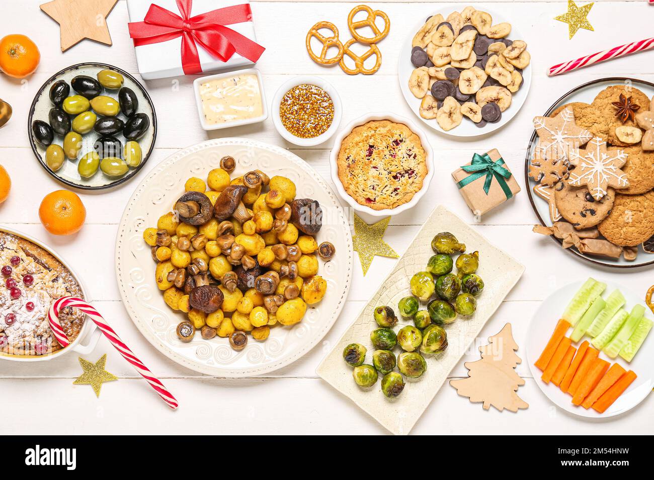 Christmas table setting with tasty food and decor on white wooden ...