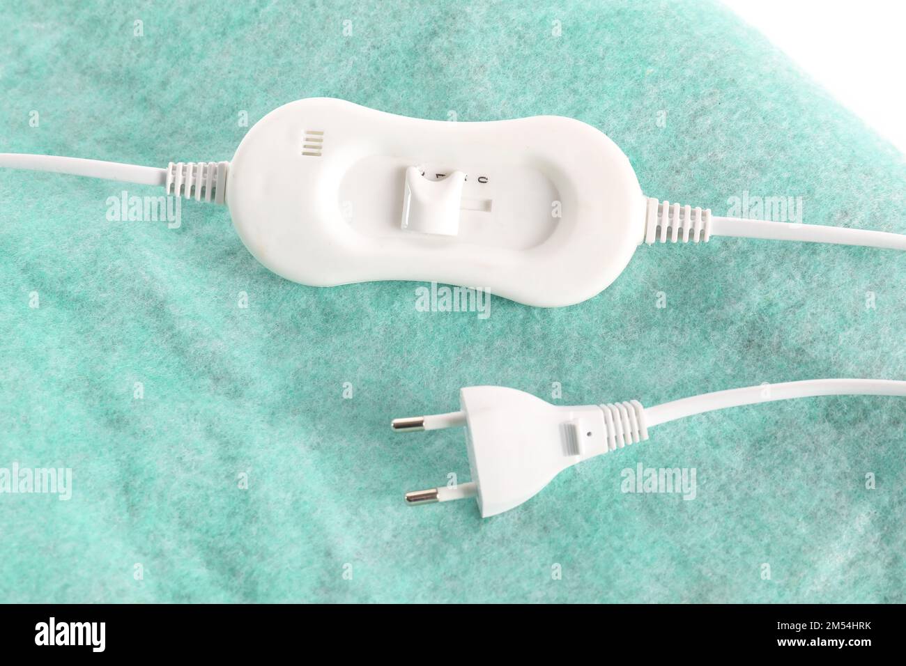 Electric heating pad with controller and plug on white background ...