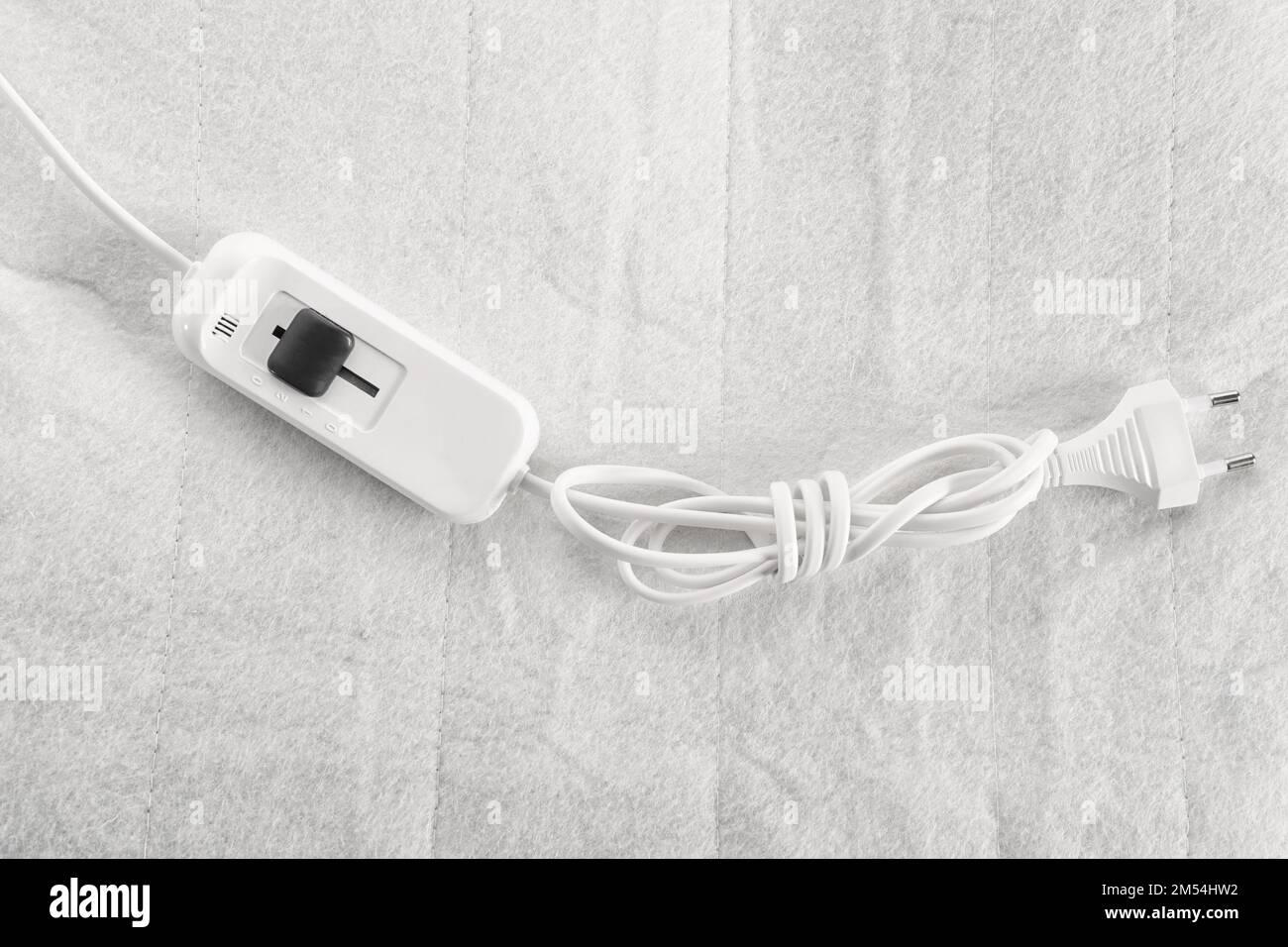 Controller with plug on white electric heating pad, closeup Stock Photo ...