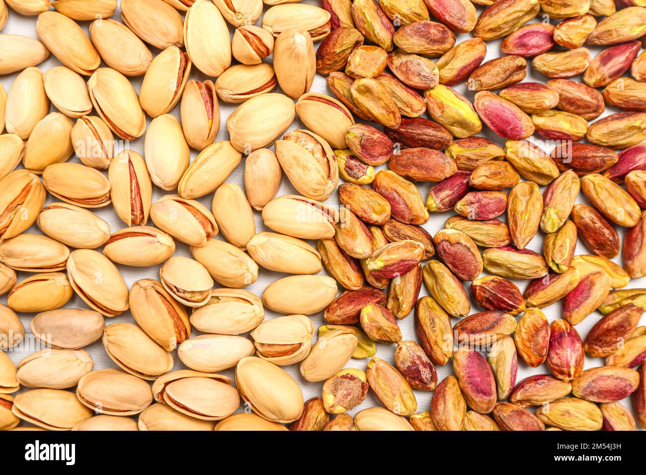 Peeled and unpeeled pistachio nuts as background Stock Photo - Alamy