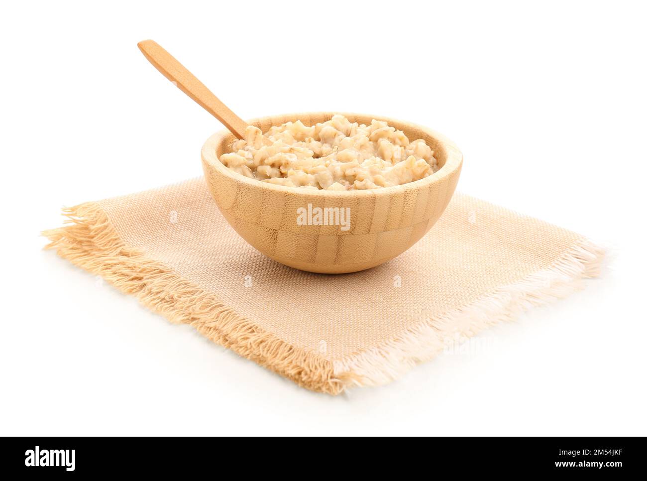 Wooden bowl with tasty oatmeal, spoon and napkin isolated on white ...