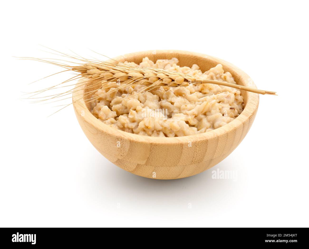 Wooden bowl with tasty oatmeal and wheat ear isolated on white ...