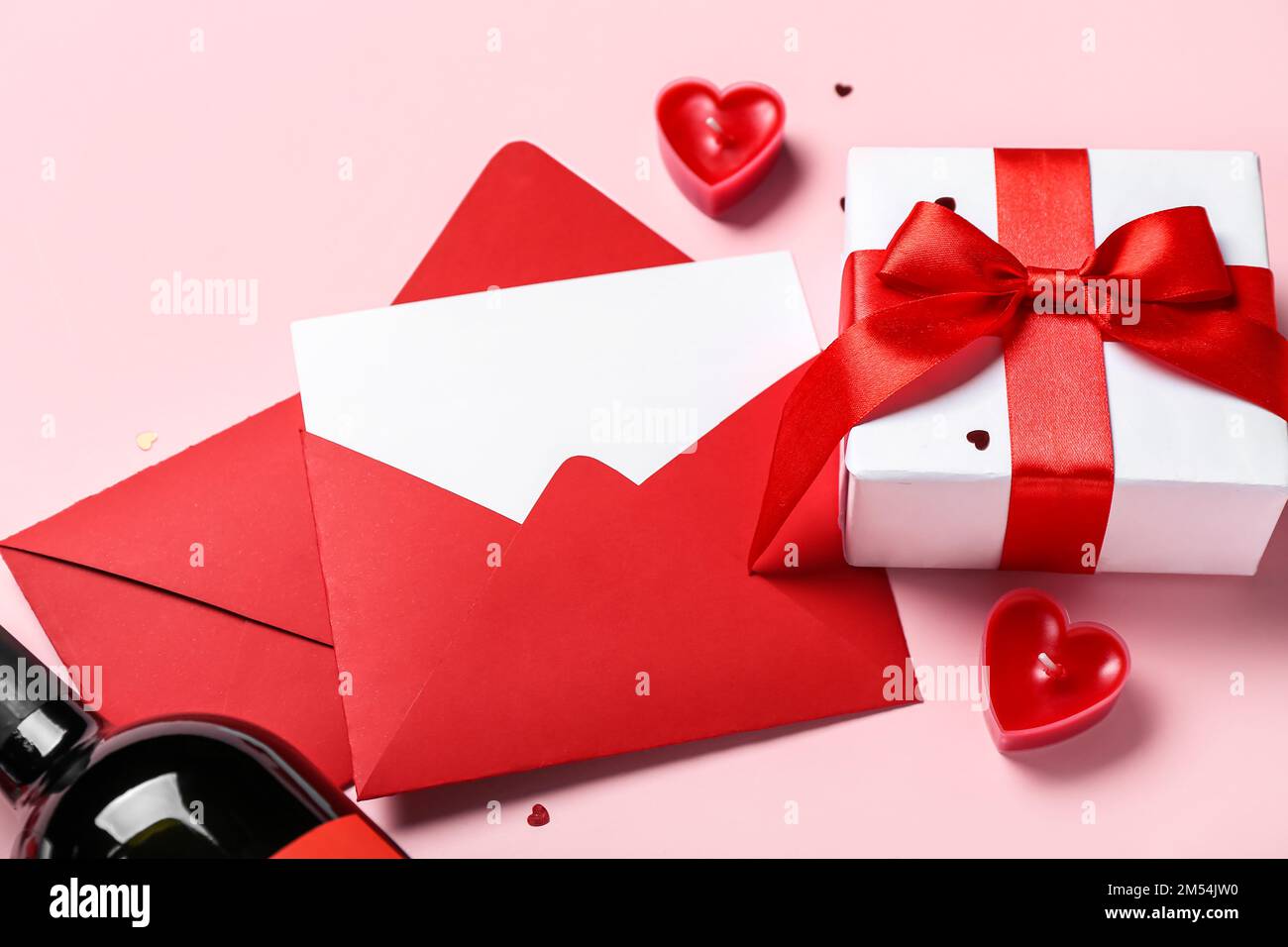 Envelopes with gift and candles on pink background. Valentine's Day ...