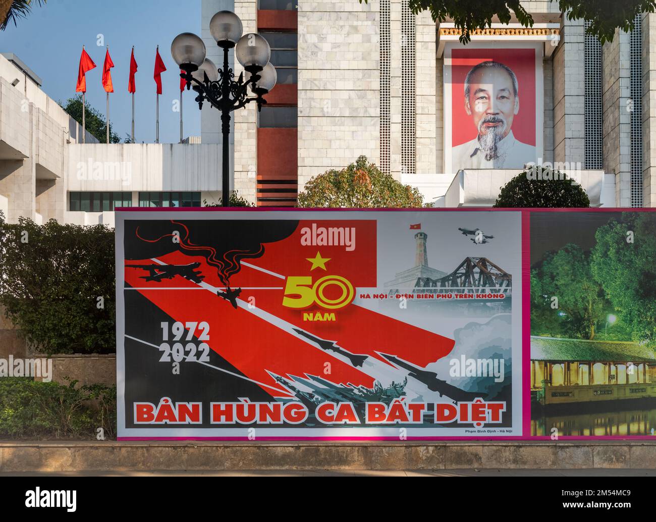 A Communist party propaganda poster in from of a large portrait of ...