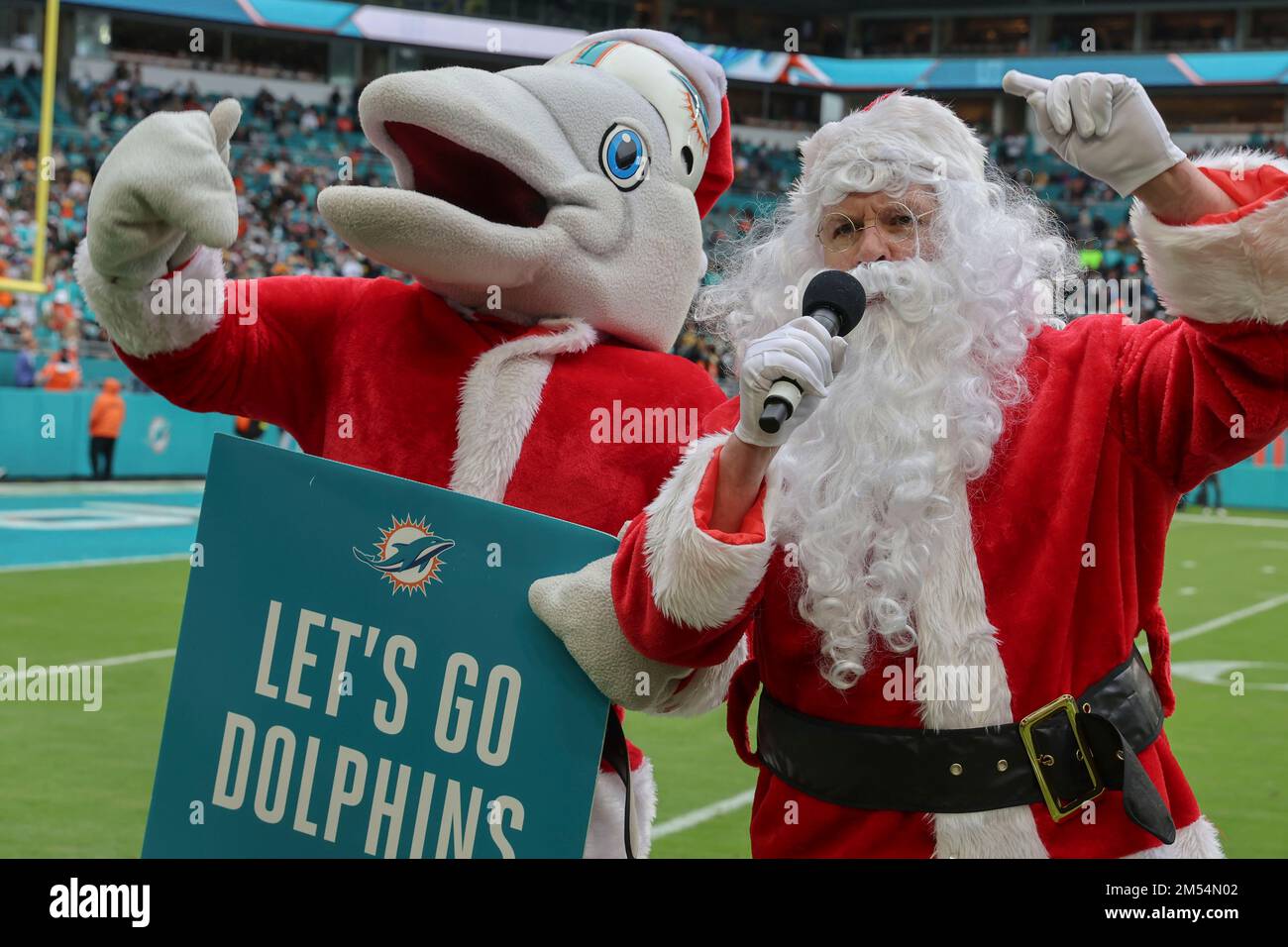 Miami. FL USA; Miami Dolphins mascot T.D. and Santa Claus cheer on the ...