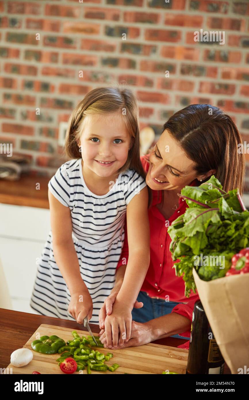 Learning family cooking secrets from mom. Portrait of a cute little ...