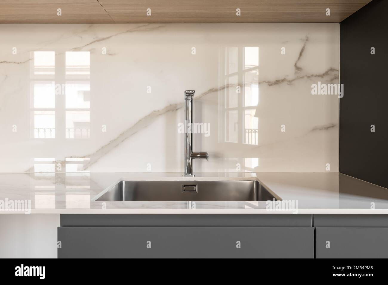 Modern small square sink in the kitchen. Fashionable built-in stainless ...
