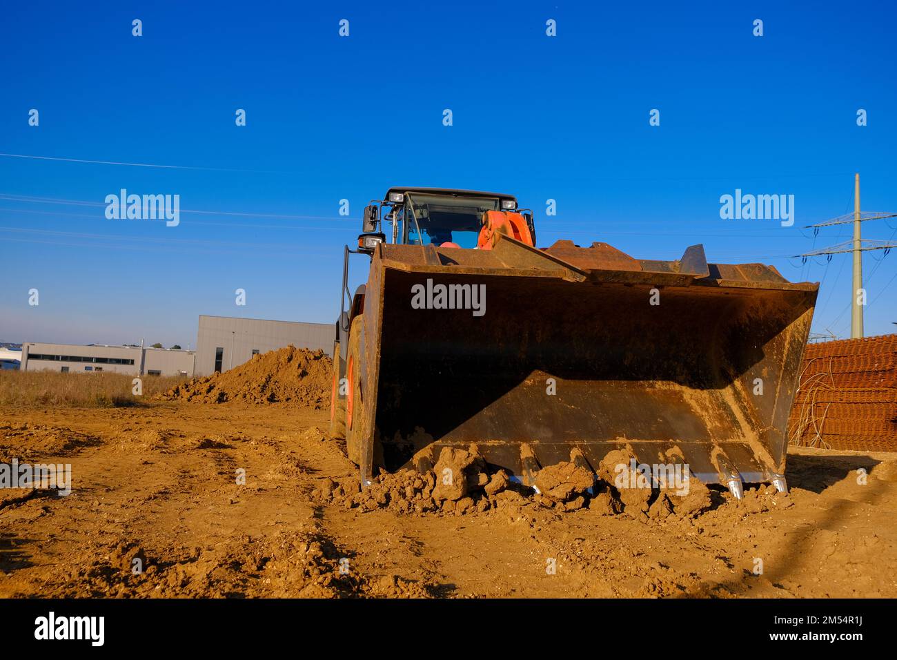 tractor with bucket in sand and clay.Excavator at construction site on ...