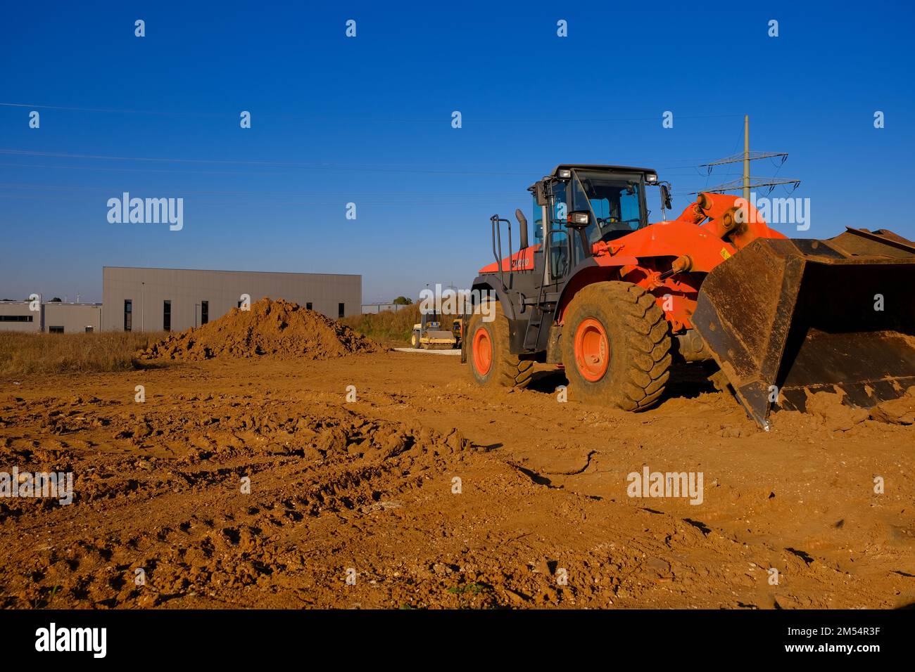 tractor with bucket close-up in sand and clay.Excavator at construction ...