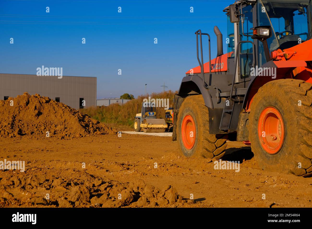 Construction tractor with bucket close-up in sand and clay.Excavator at ...